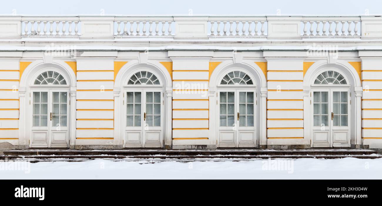 Old white wooden doors in yellow outdoor wall, background texture ...