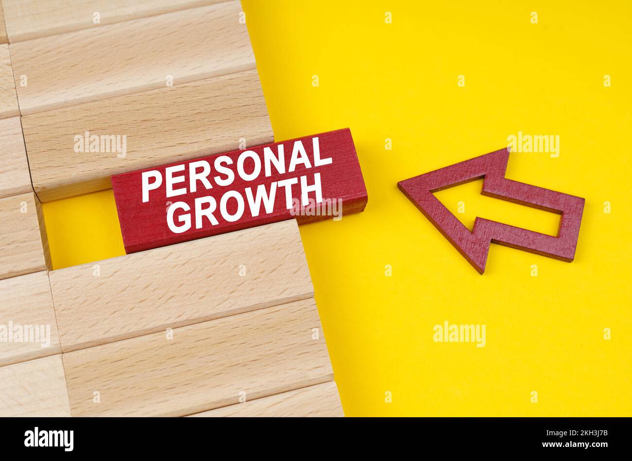 Business concept. On a yellow surface are wooden blocks and an arrow ...