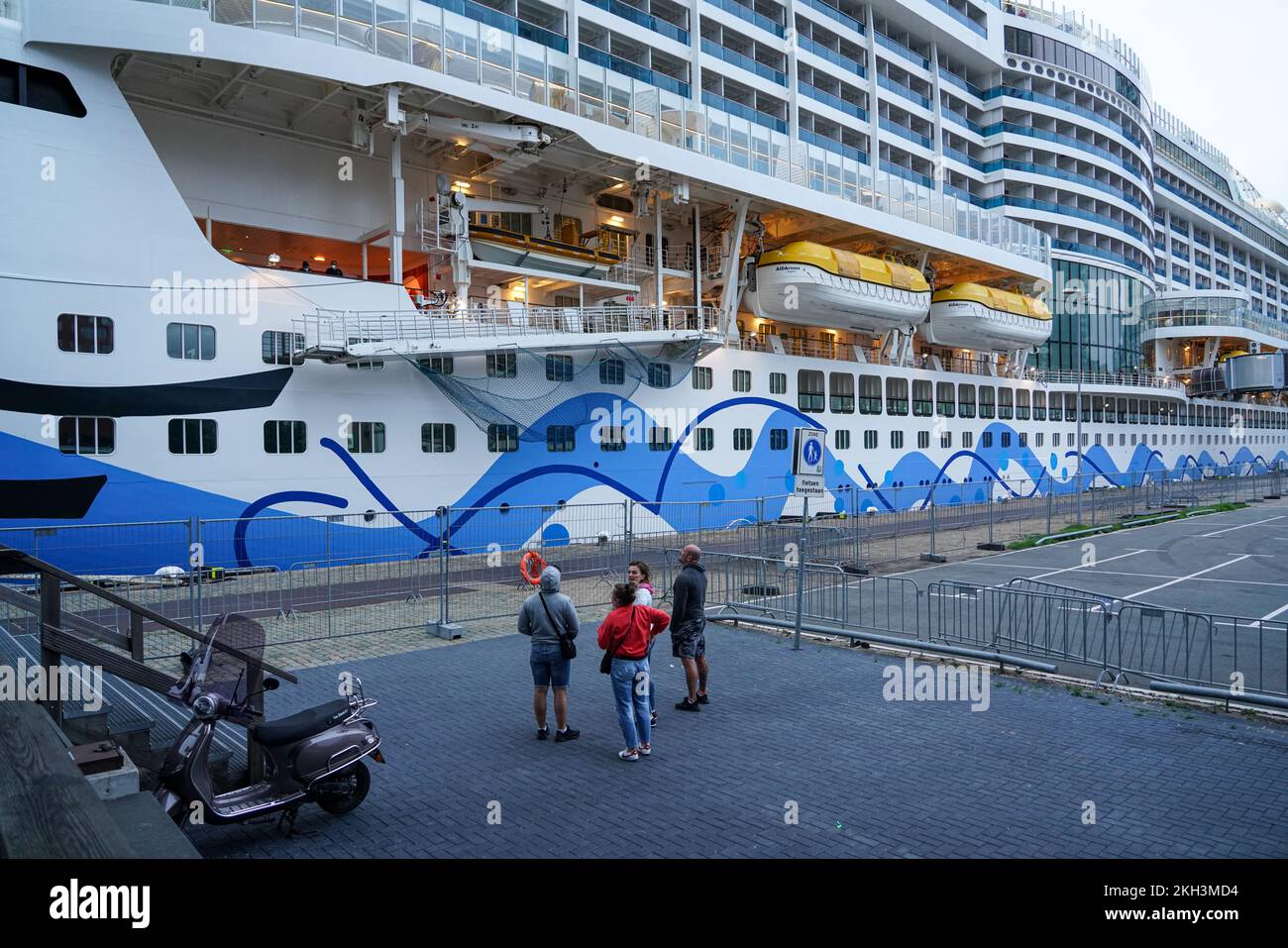 Four tourists admire the 300 meter long and 37 meter wide cruise ship ...