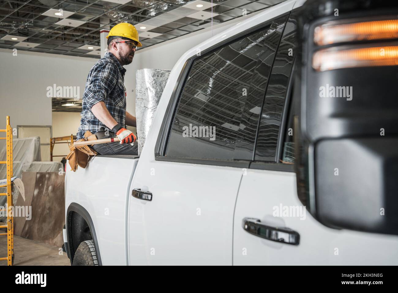 Caucasian Middle Aged Contractor Sitting in the Cargo Bed of White ...