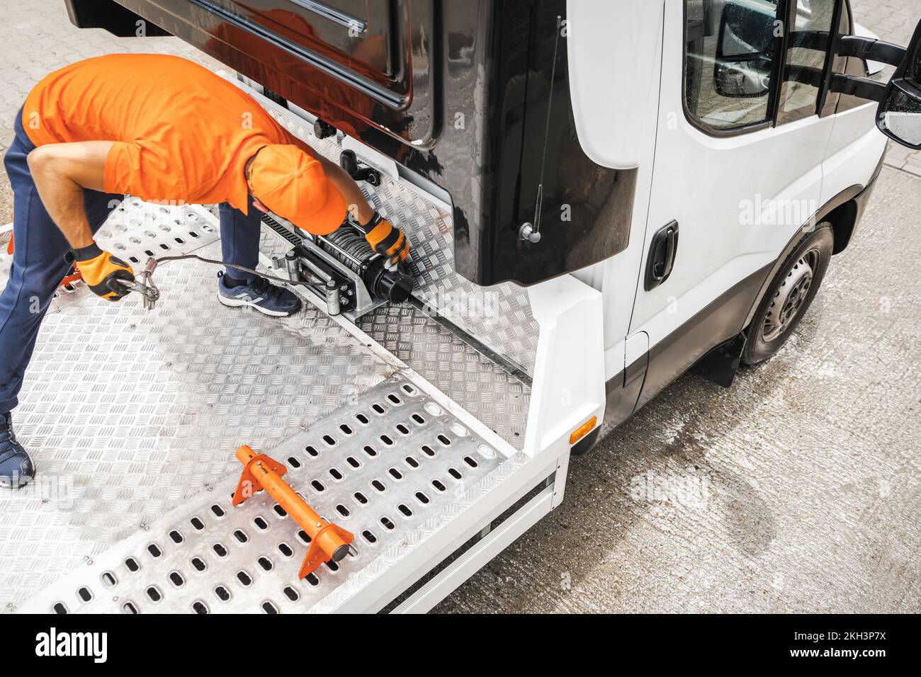 Professional Tow Truck Driver Preparing Hydraulic Winch for Loading the ...