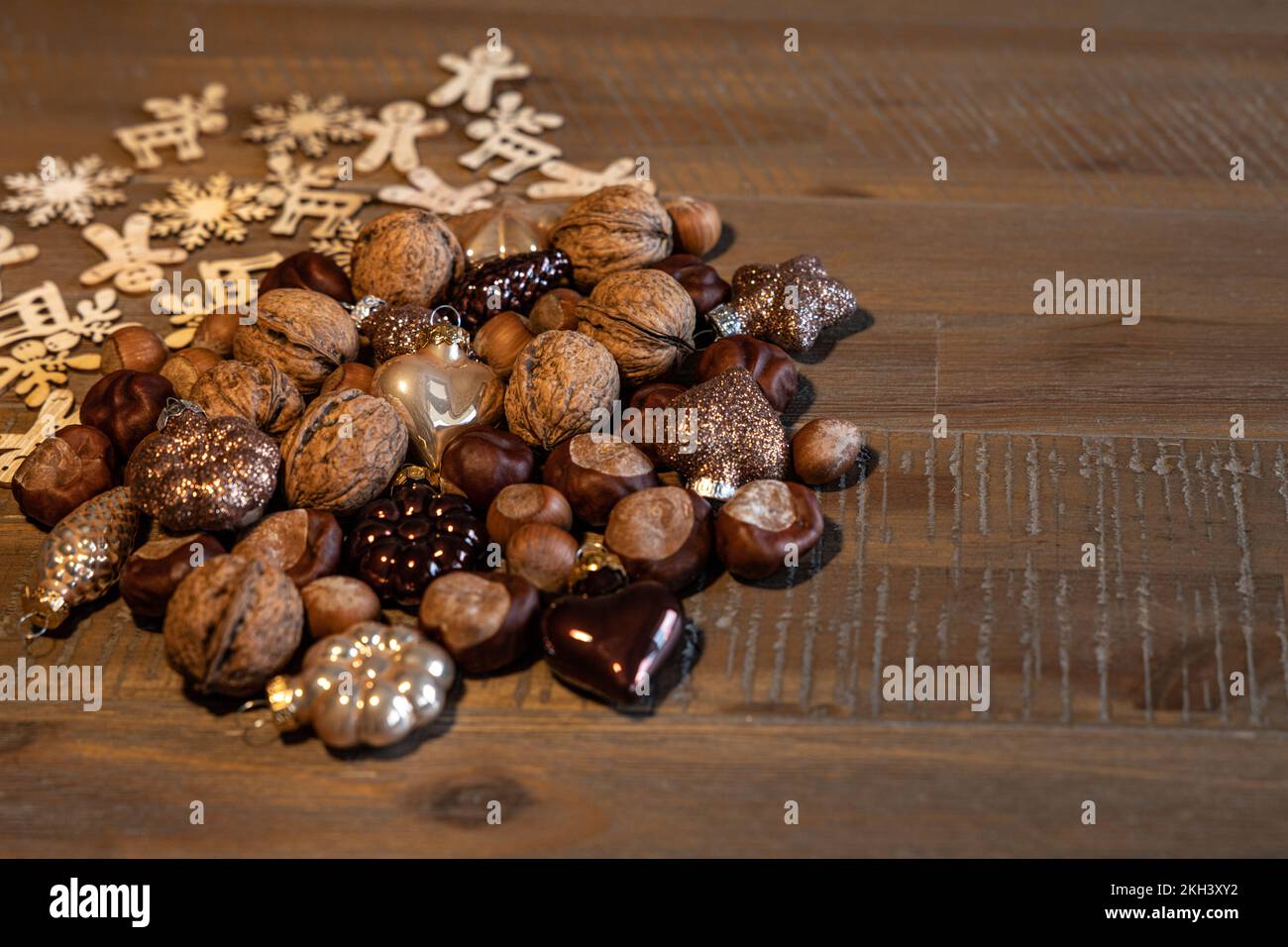 Different types of nuts and Christmas tree decorations are arranged on ...