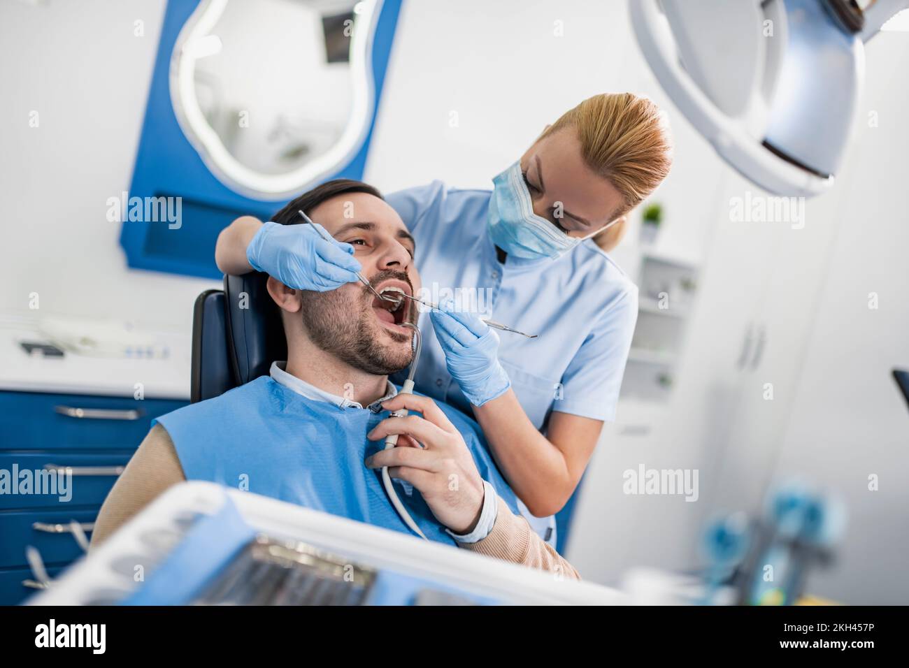 Woman dentist at work with patient.Dental care,taking care of teeth ...