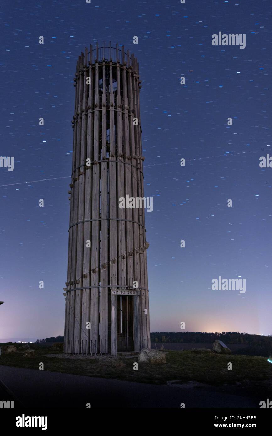 A vertical breathtaking view of Acacia lookout tower with star trails ...