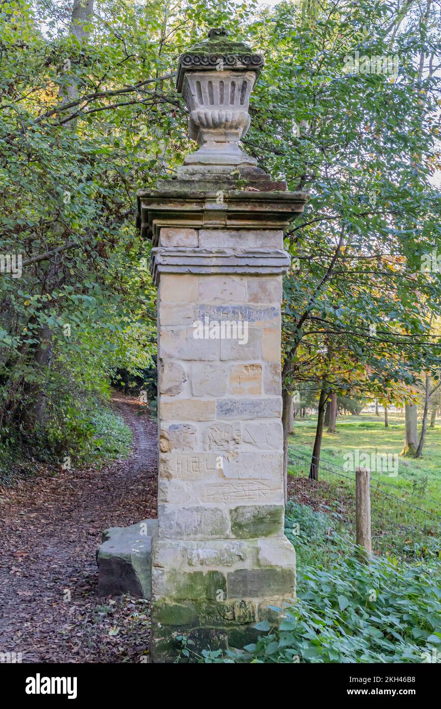 Ancient limestone pillar with an ornament on top at entrance to ...