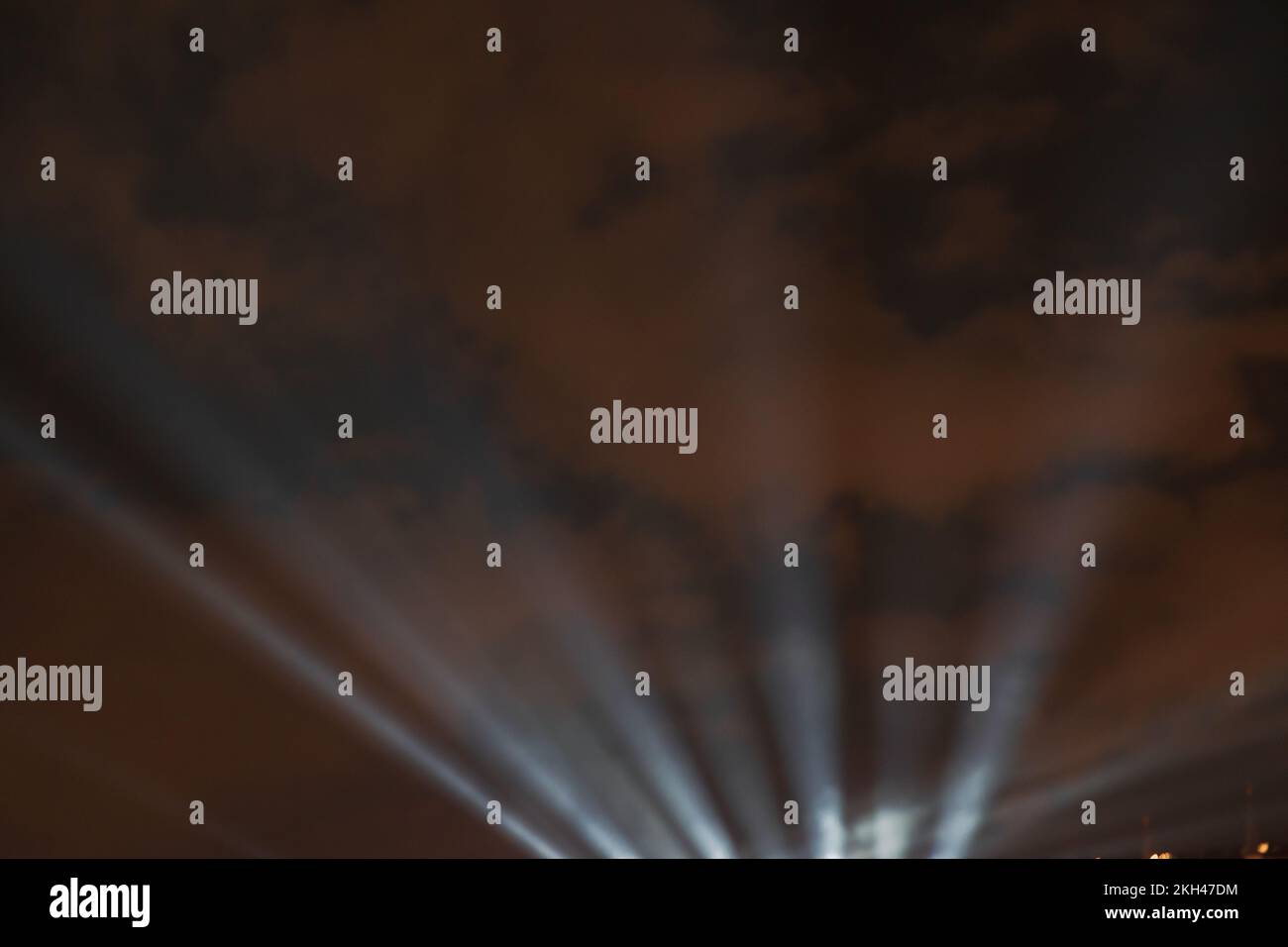 Spotlight rays with cloudy sky at night. Projector light beams Stock ...