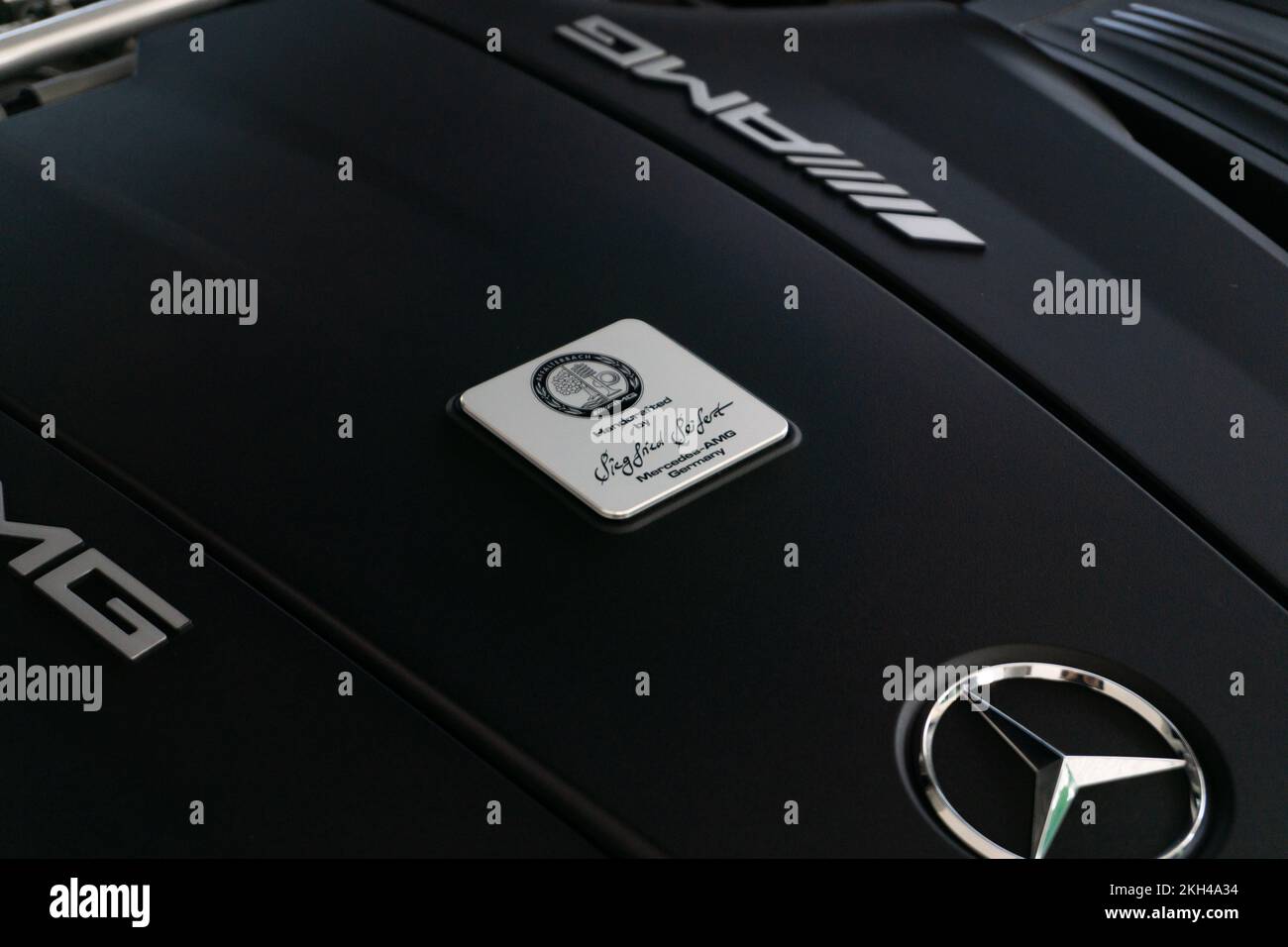 A closeup of the cover plaque of a luxurious black Mercedes Benz AMG GT ...