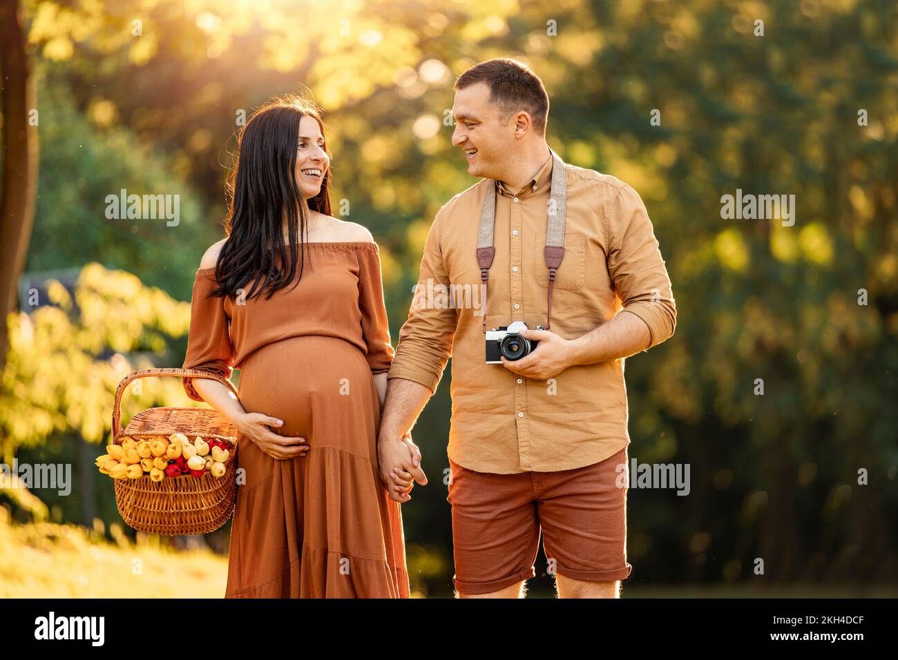 Happy pregnant couple hugging in nature.Husband with his pregnant wife ...
