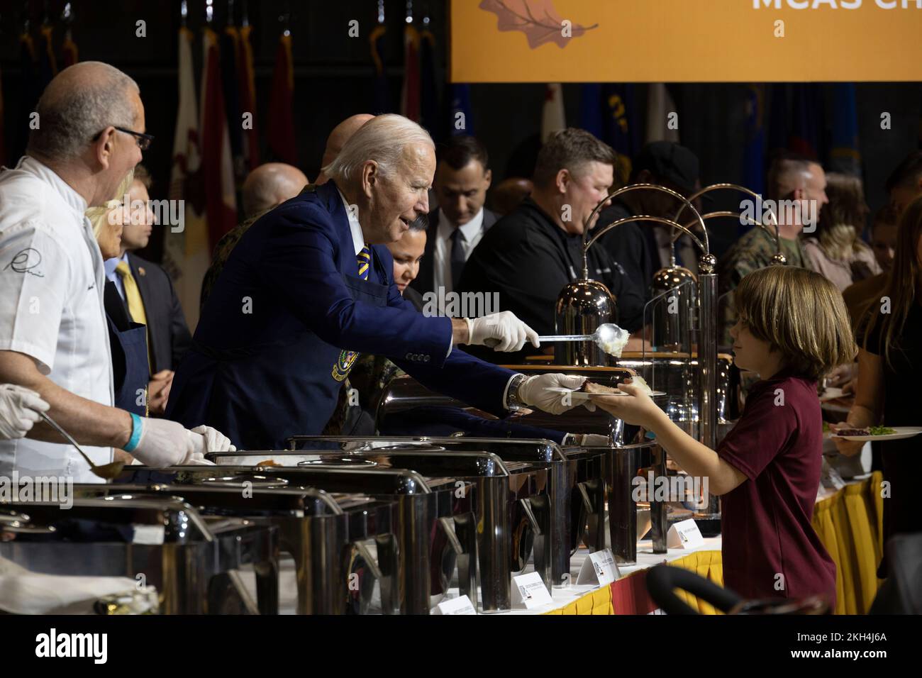 U.S. President Joseph R. Biden loads a young military family member’s ...