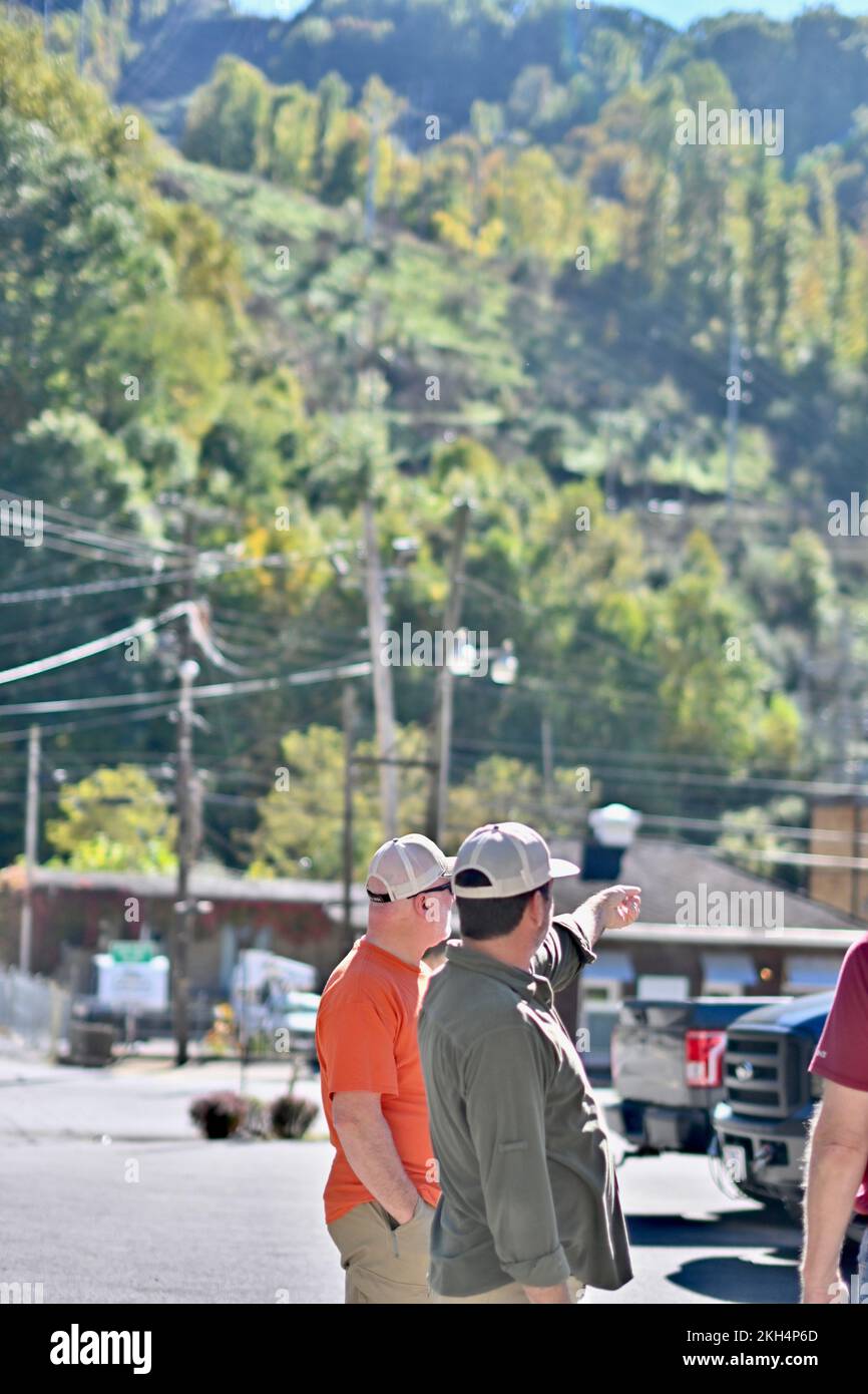A vertical shot of two men standing outside a coal mine in Kentucky ...