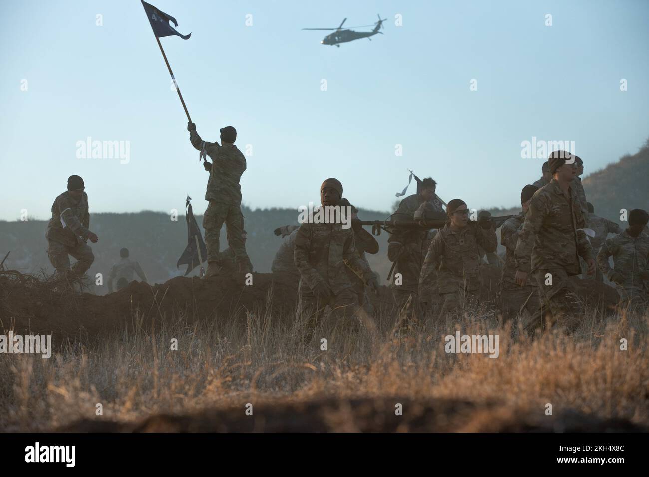 Soldiers assigned to the 4th Infantry Division climb through a ditch ...