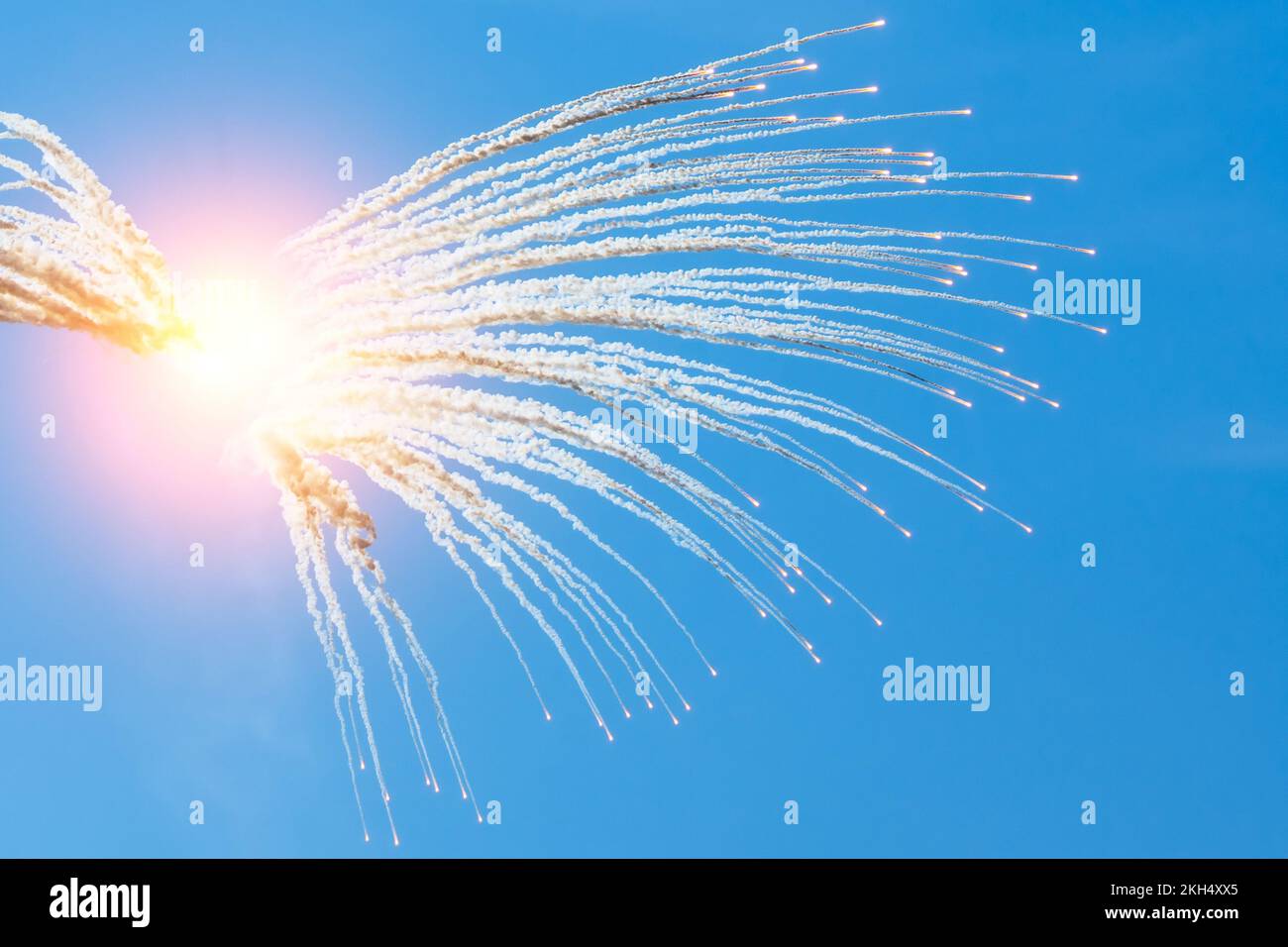 Explosion of a shell in the sky and burning debris flying with smoke ...