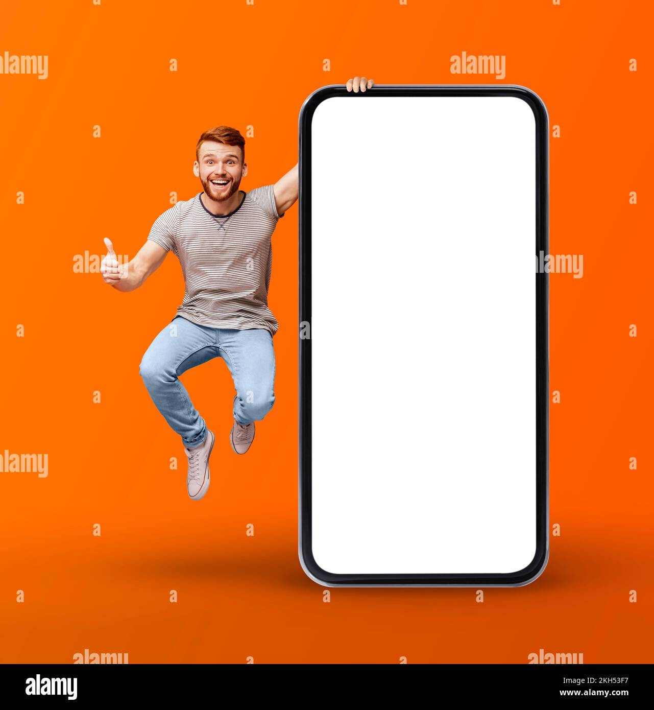 Mobile Ad. Excited Man Jumping With Blank Smartphone And Showing Thumb ...
