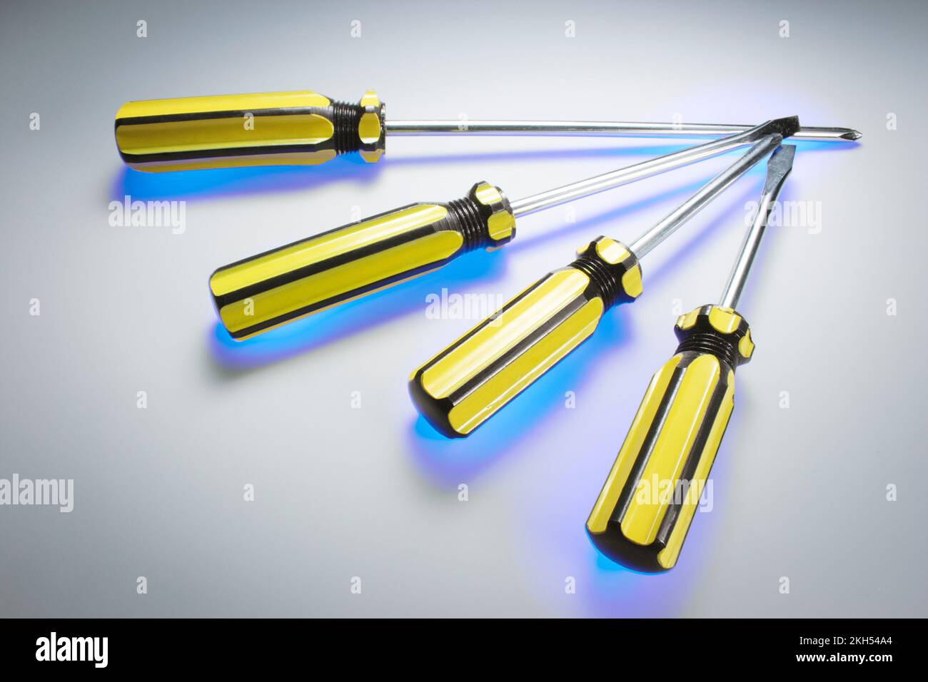 Screw Drivers on Blue Background Stock Photo - Alamy