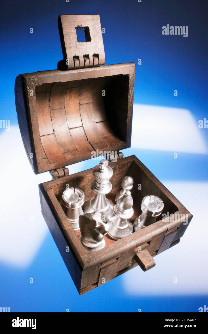 Wooden Chest with Chess Pieces on Blue Background Stock Photo - Alamy