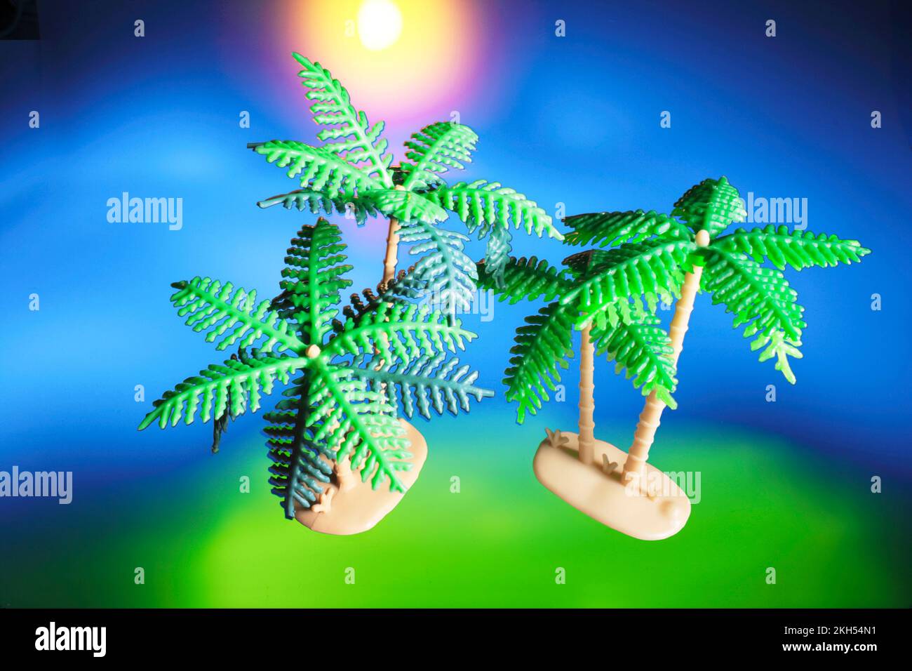 Plastic Palm trees on Blue Background Stock Photo - Alamy