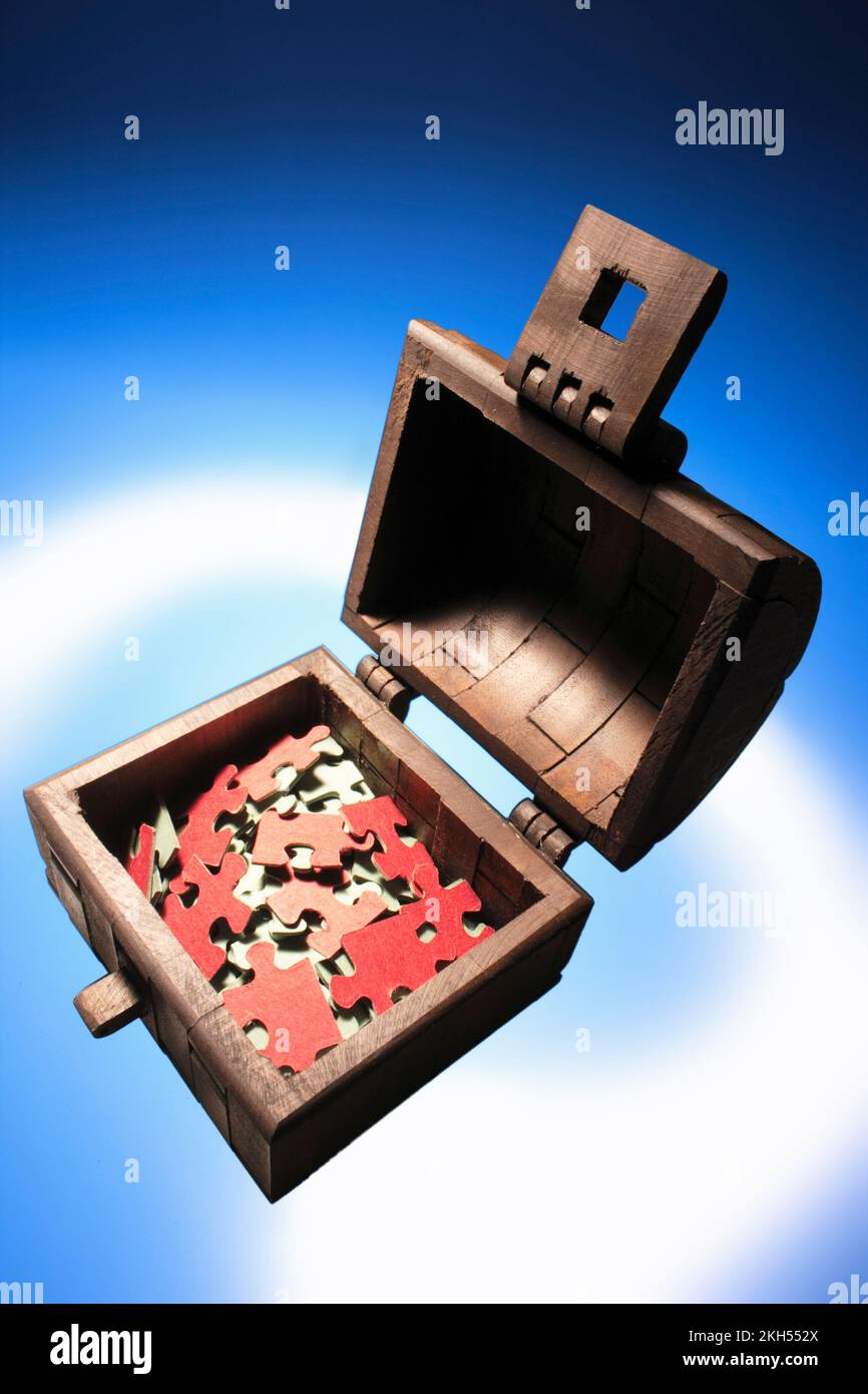Wooden Chest with Jigsaw Puzzle Pieces on Blue Background Stock Photo ...