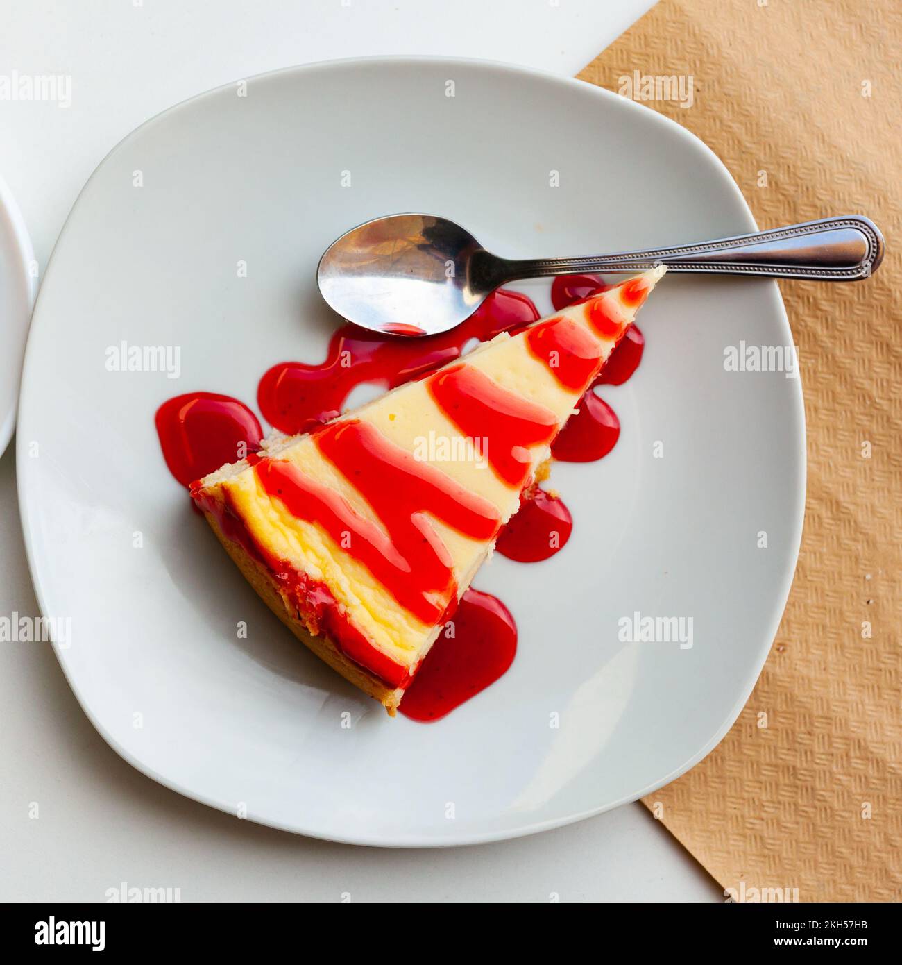 Slice of classic New York cheesecake with strawberry sauce Stock Photo ...