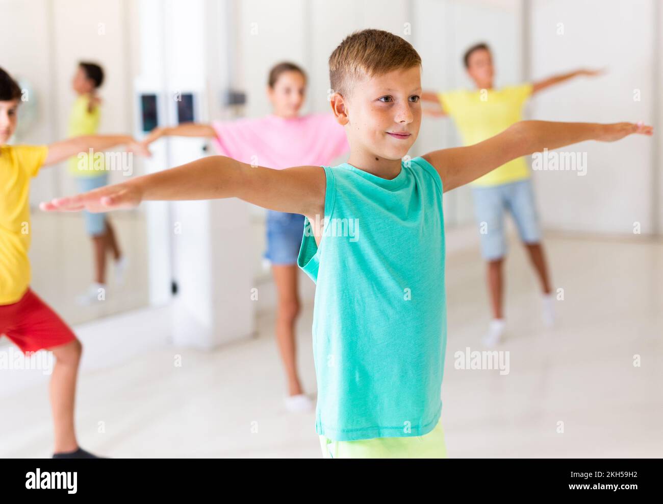 Group children learn dance movements in class Stock Photo - Alamy
