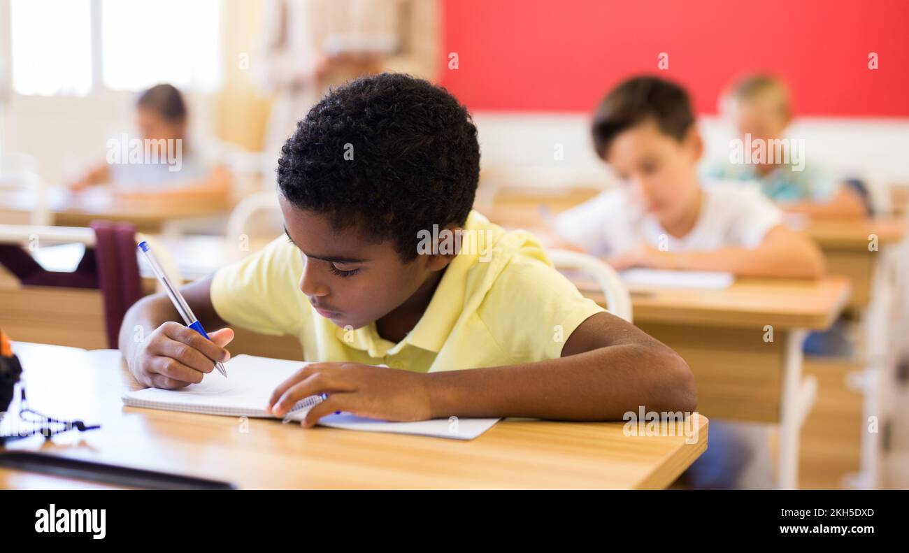 Portrait african american schoolboy sitting hi-res stock photography ...
