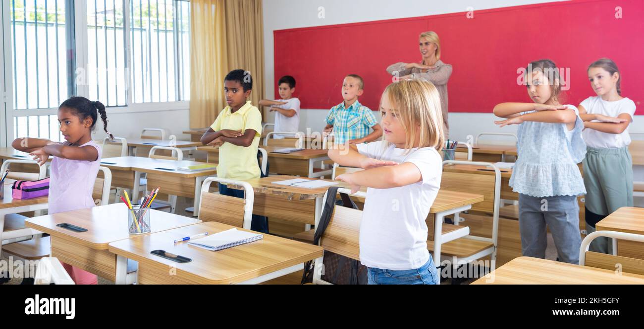 Tweens with female teacher during physical activity break Stock Photo ...