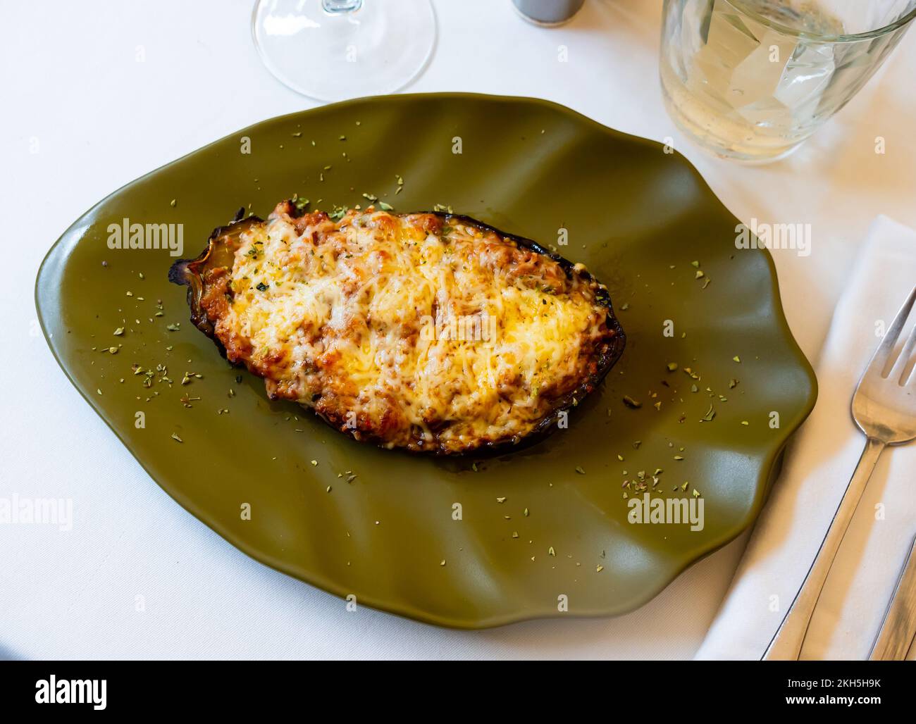 Baked half of eggplant gratinated with cheese Stock Photo - Alamy
