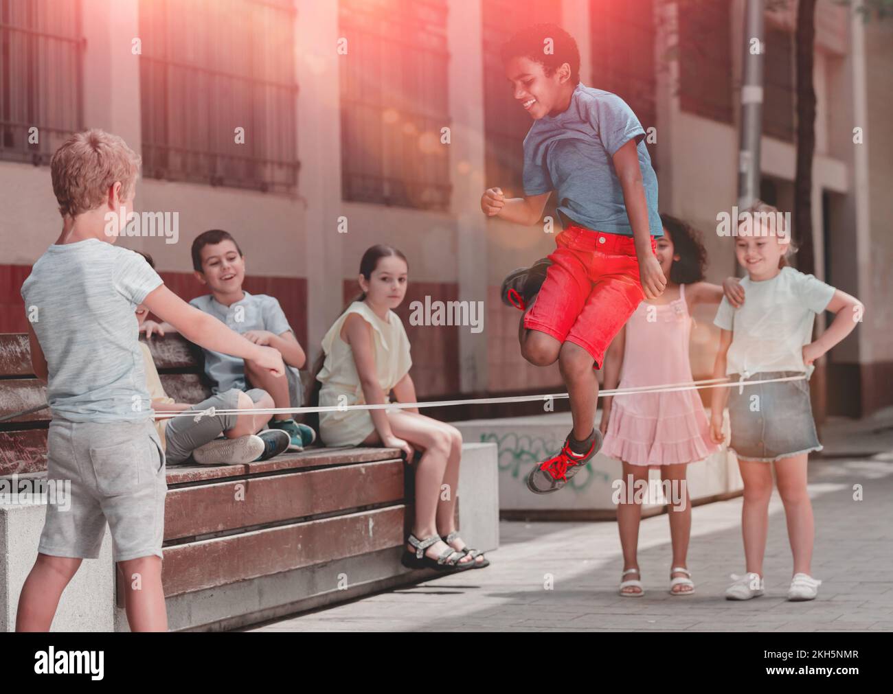 Mexican boy playing rubber band jumping game with friends Stock Photo ...