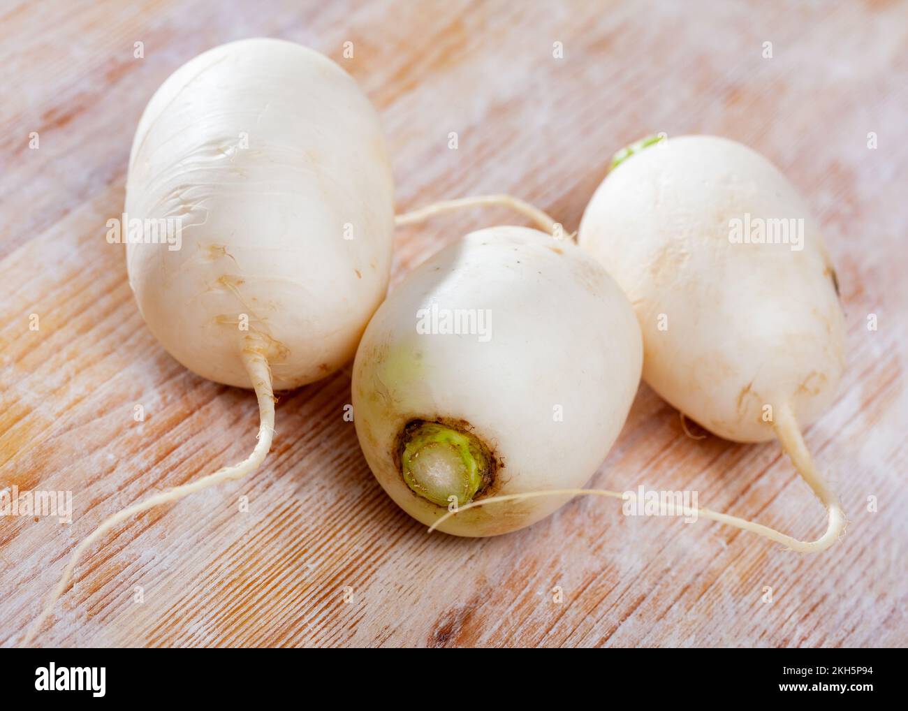 Whole white radishes on wooden surface Stock Photo - Alamy