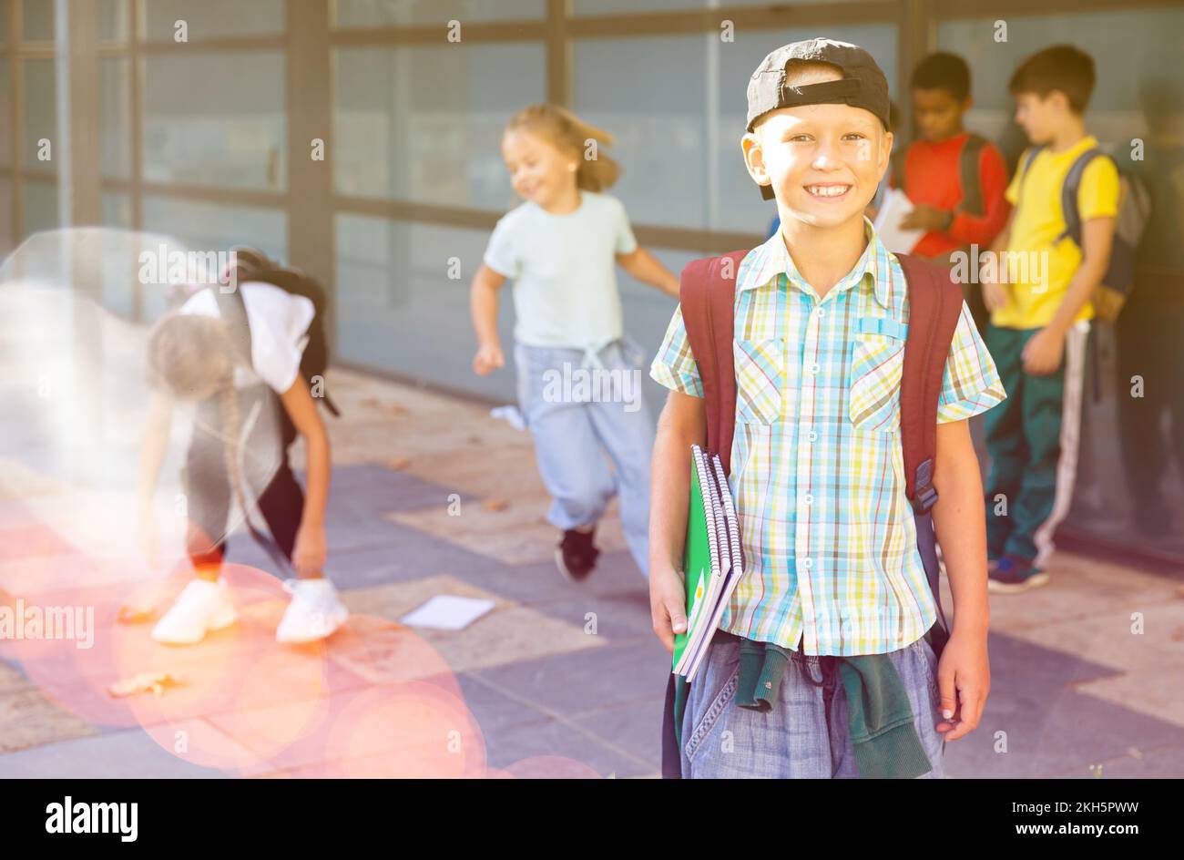 Smiling primary school boy standing outdoors Stock Photo - Alamy