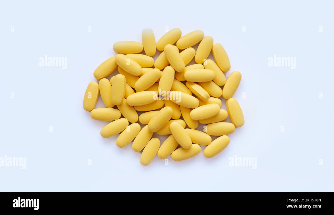 Close-up texture of yellow multivitamin tablets on white background ...