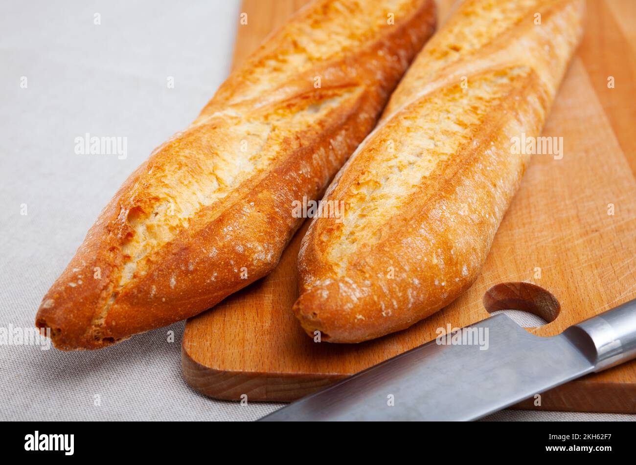 Fresh bread on a wooden cutting board Stock Photo - Alamy
