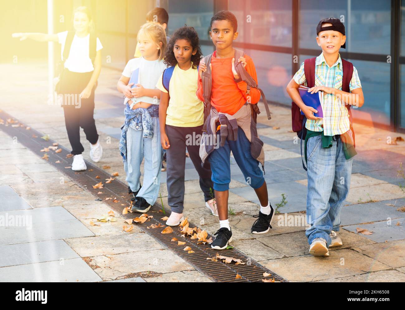 Group of children walking near school Stock Photo - Alamy