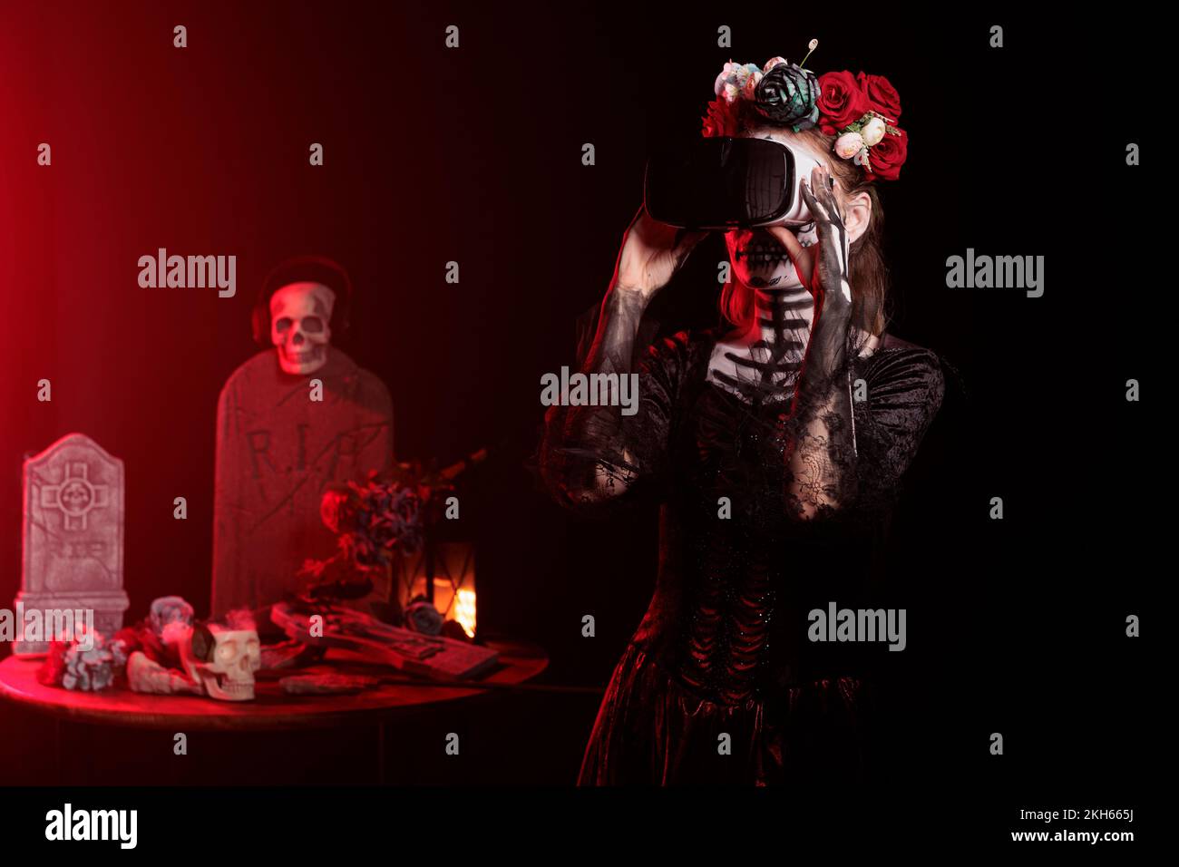 Young adult using vr glasses on day of the dead holiday, holding ...