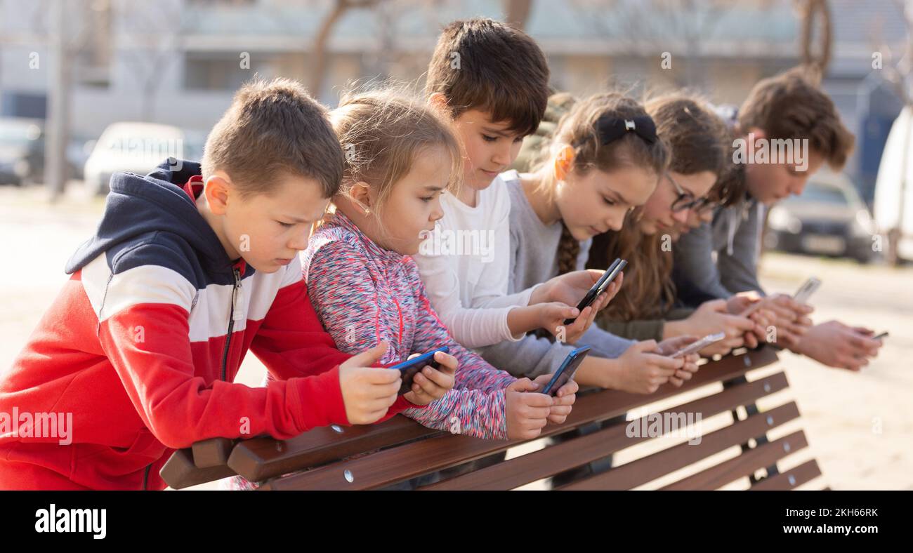 Group of children communicate using smartphones in the playground Stock ...