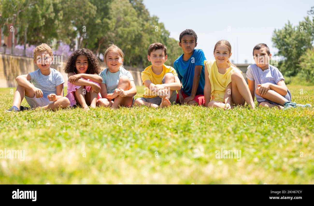 Group of happy kids on green grass in park Stock Photo - Alamy