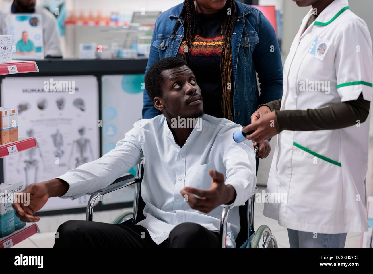 Pharmacy consultant explaining man with disability medications ...