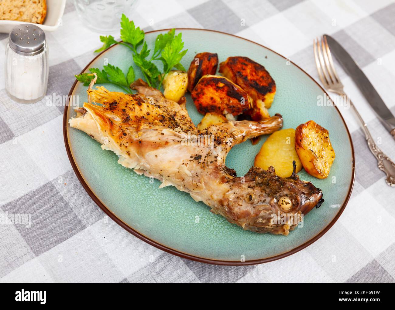 Baked rabbit and potato slices with fresh parsley Stock Photo - Alamy