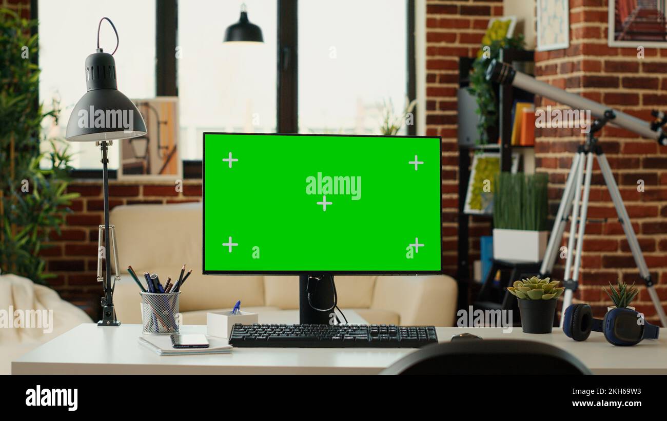Empty office with monitor and greenscreen on computer, showing chroma key display and isolated ...