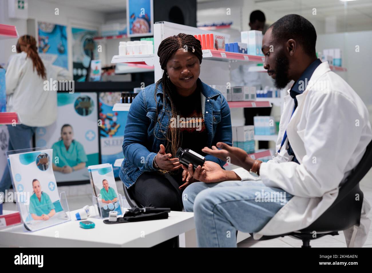 Pharmacy consultation, african american client buying pills bottle in ...