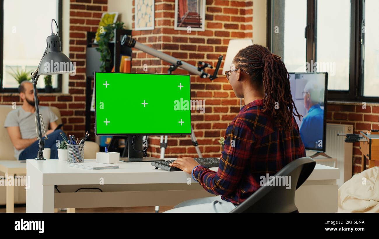African american freelancer watching computer with greenscreen template ...