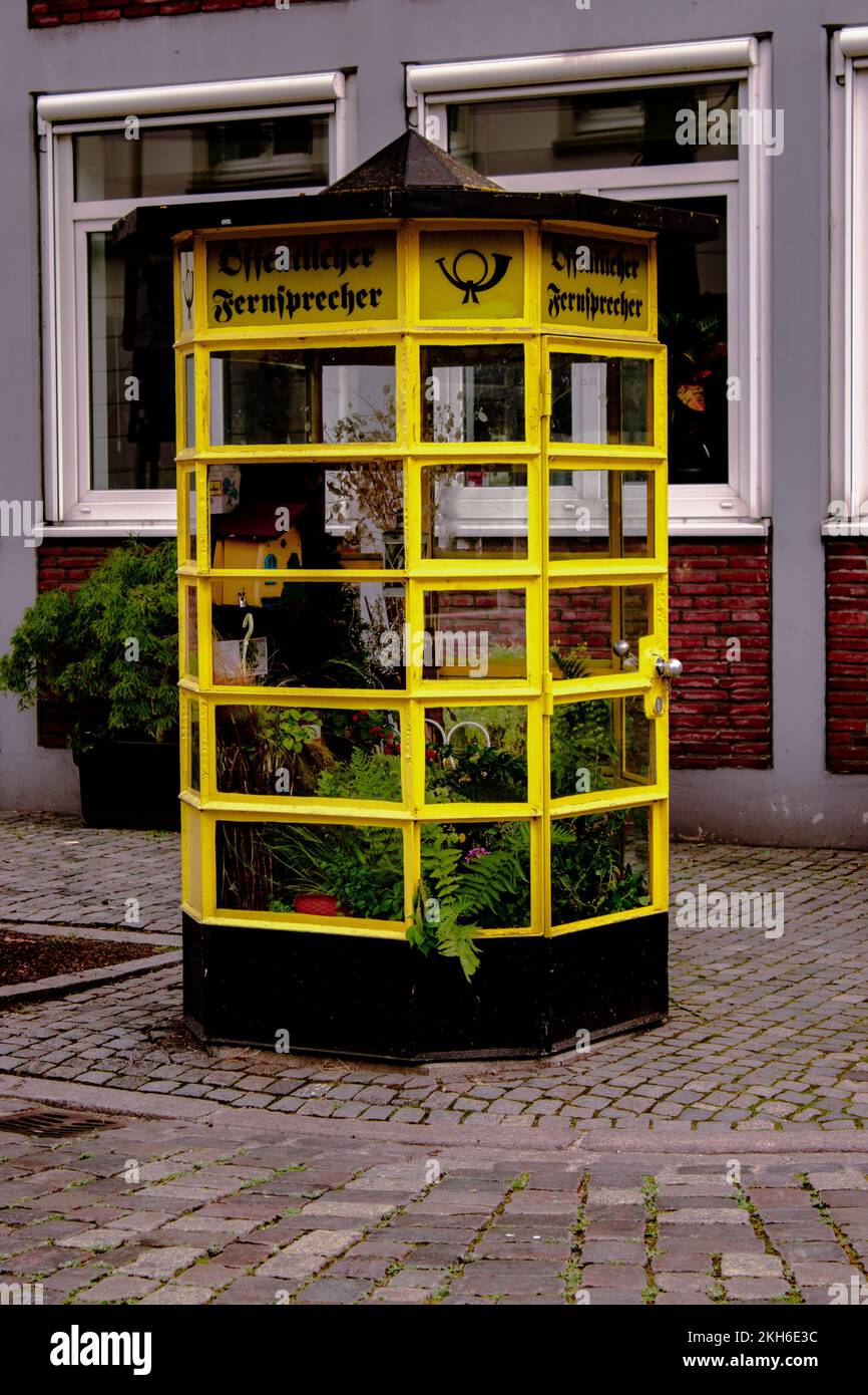 A vertical view of a historic telephone booth on a street in Bremen ...