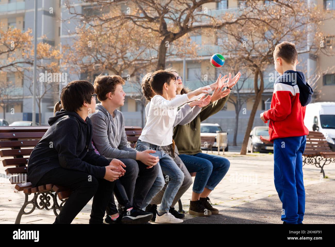 Kids playing ball together on the street Stock Photo - Alamy