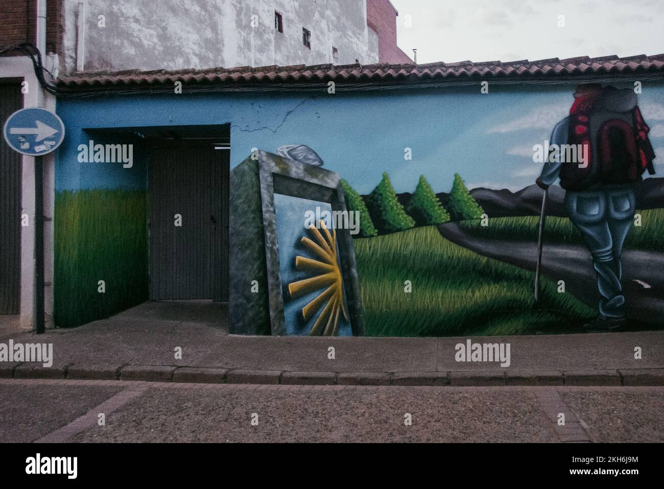 Mural of a pilgrim and a typical marker with the pilgrim's scallop ...