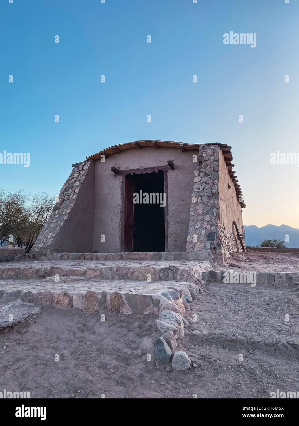 An exterior of an old adobe church under the clear sky in Catamarca ...