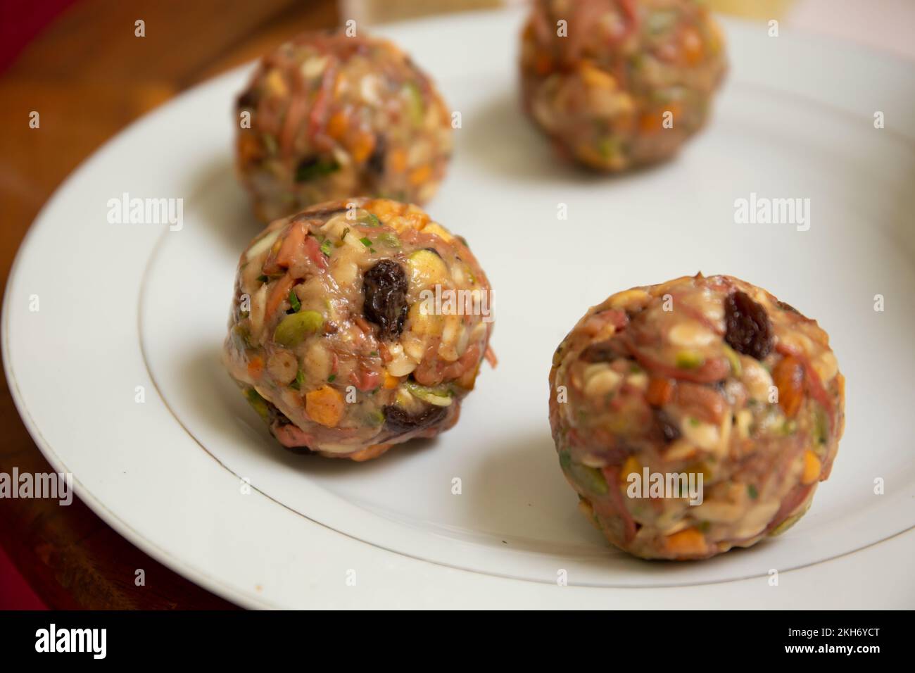 A close up of mooncake filling balls on a plate and wooden table ...