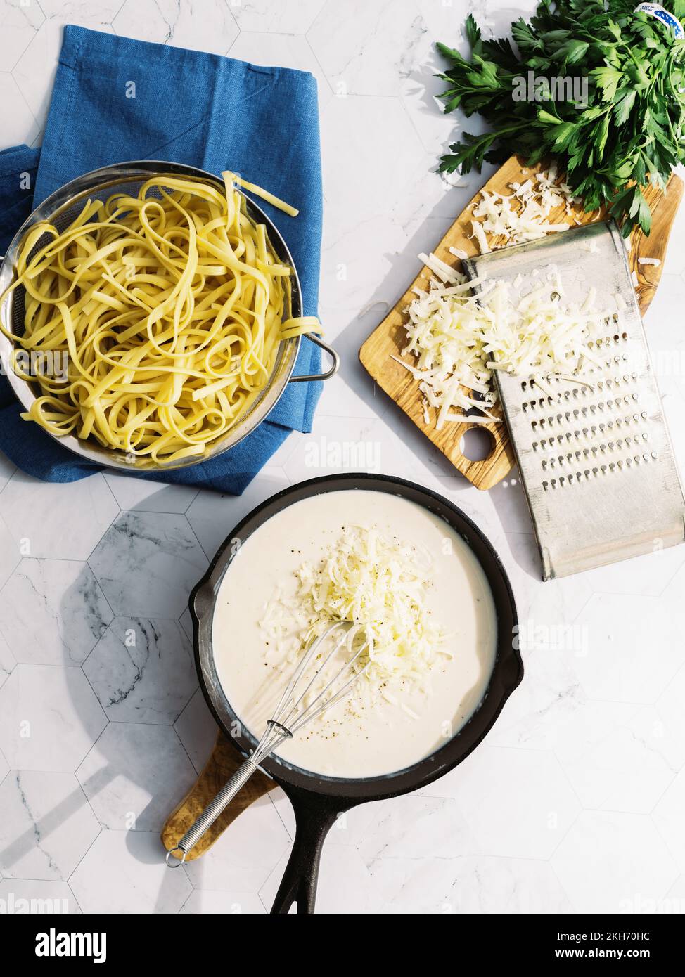A vertical shot of alfredo pasta on a marble table Stock Photo - Alamy
