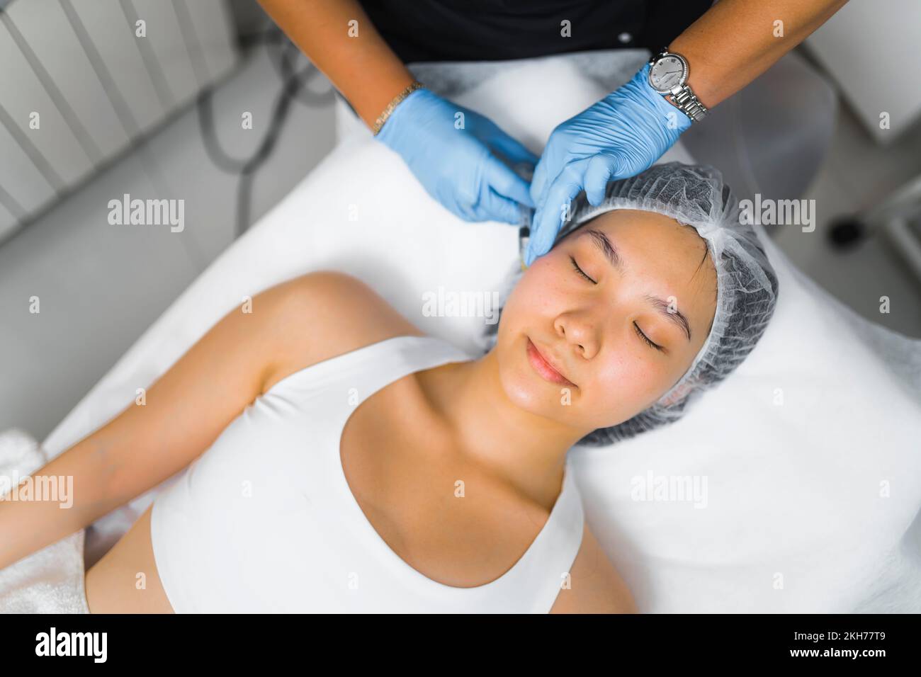 charming Asian woman taking mesotherapy at the spa center closeup aesthetic procedure. High ...