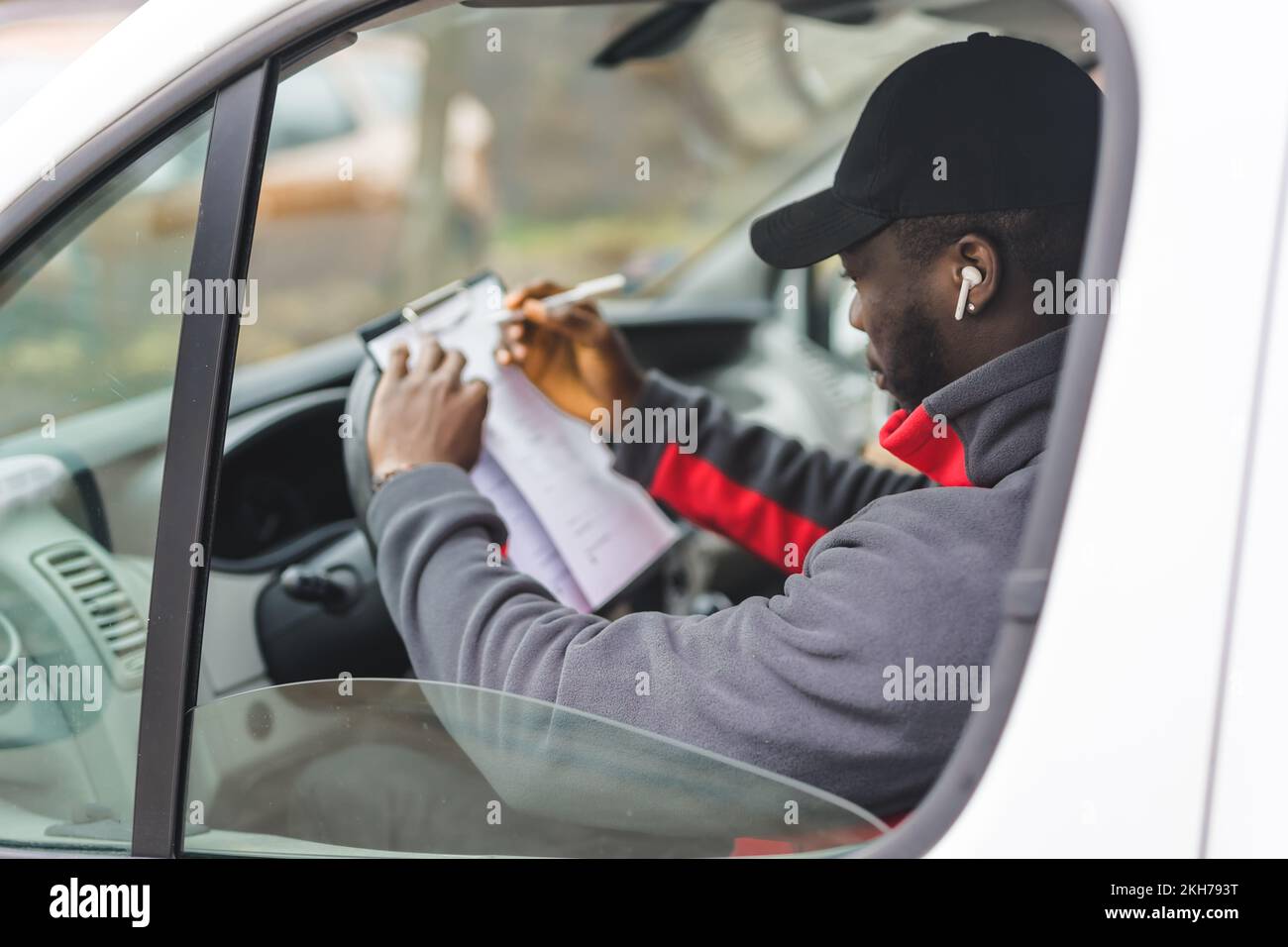 Young adult black delivery guy wearing work uniform and black cap ...