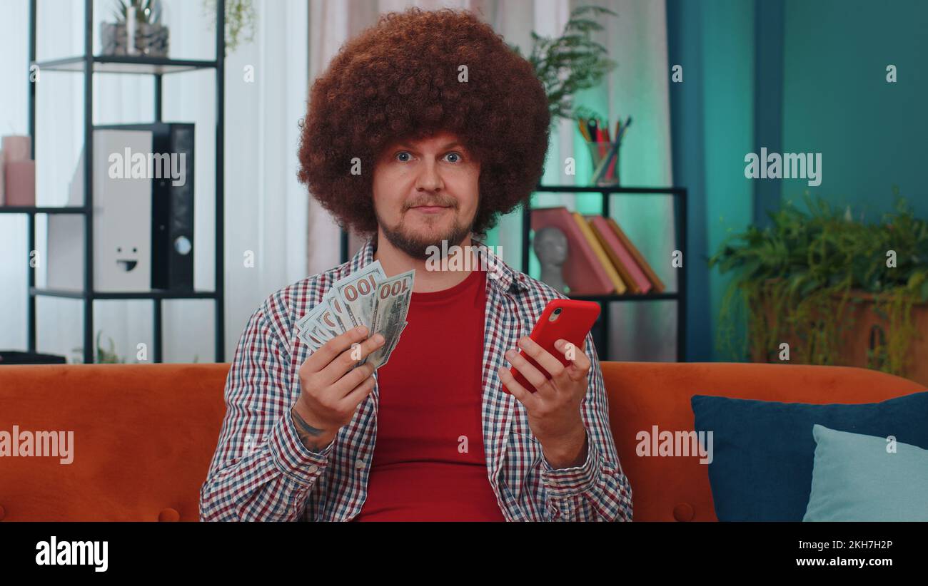 Planning family budget. Man with lush hairstyle counting money dollar ...