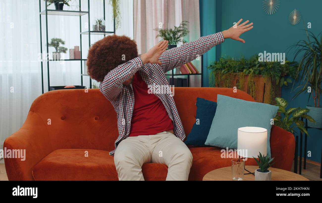 Trendy cheerful positive adult man having fun, dancing and moving to ...